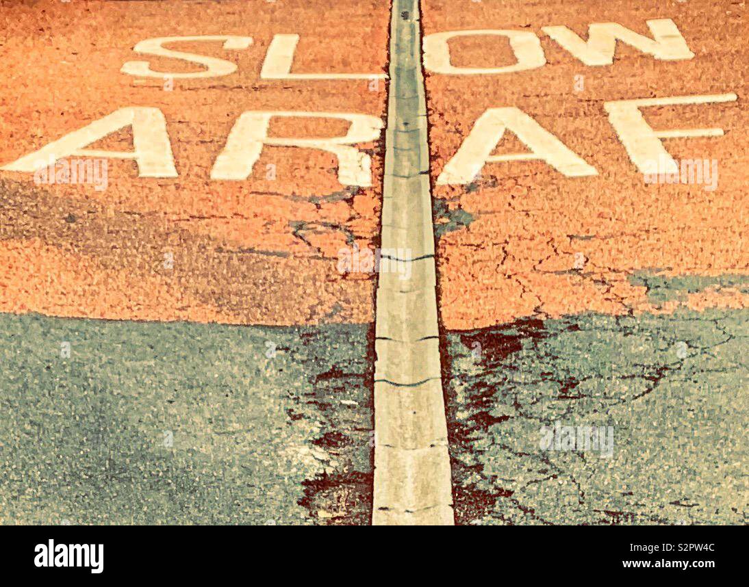 Slow road marking hi-res stock photography and images - Alamy