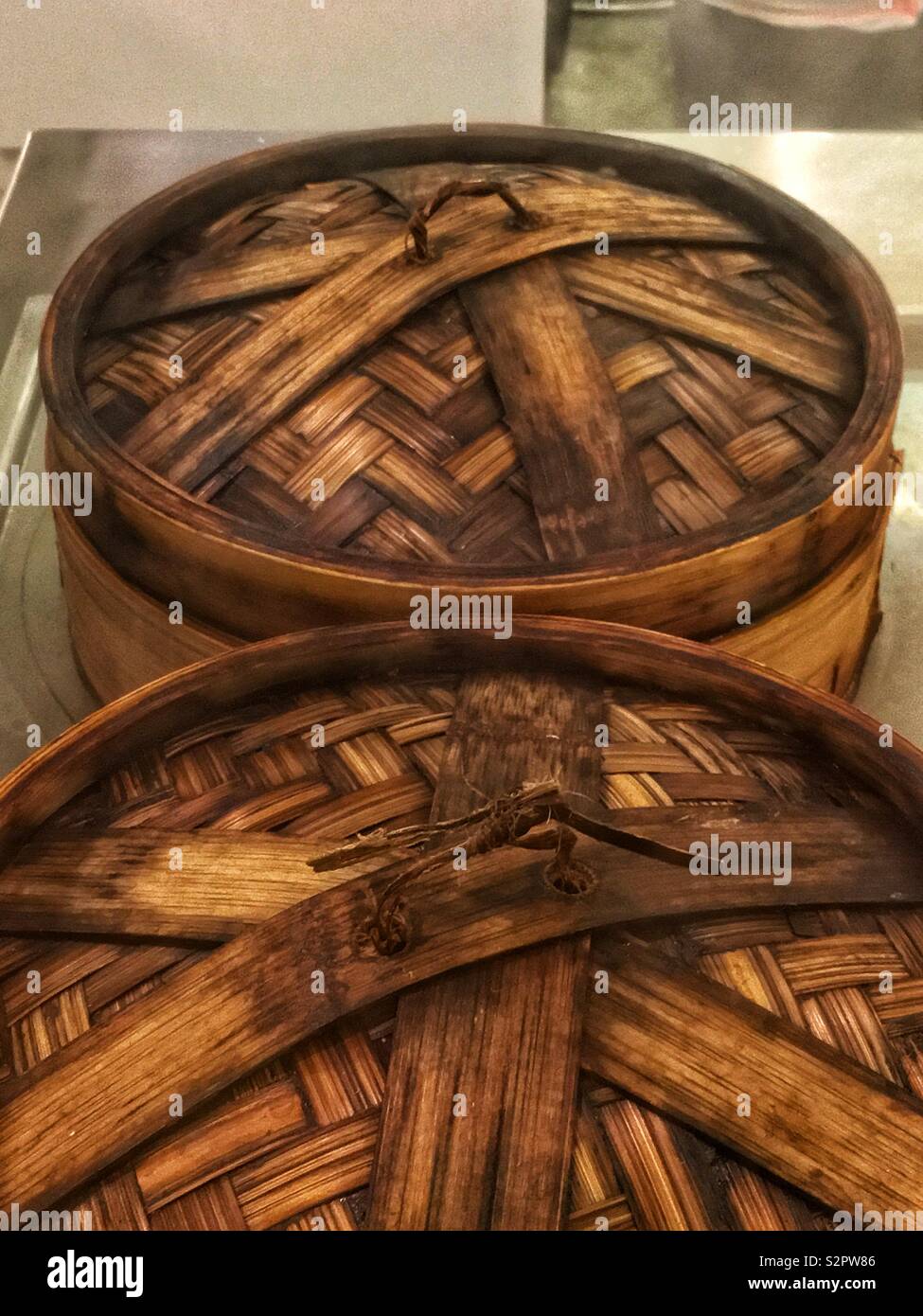 Dim sum bamboo cooking containers steaming on the stove Stock Photo - Alamy