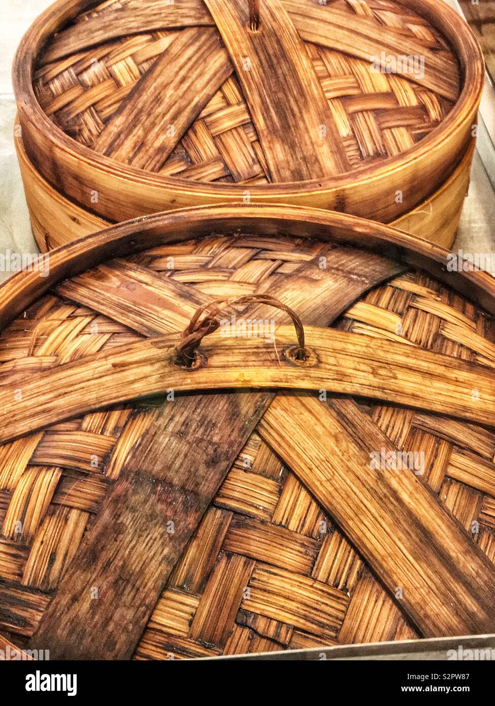 Dim sum bamboo cooking containers steaming on the stove Stock Photo - Alamy