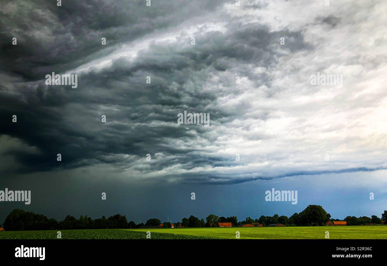 Dark threatening storm clouds rolling in over a Countryside landscape ...
