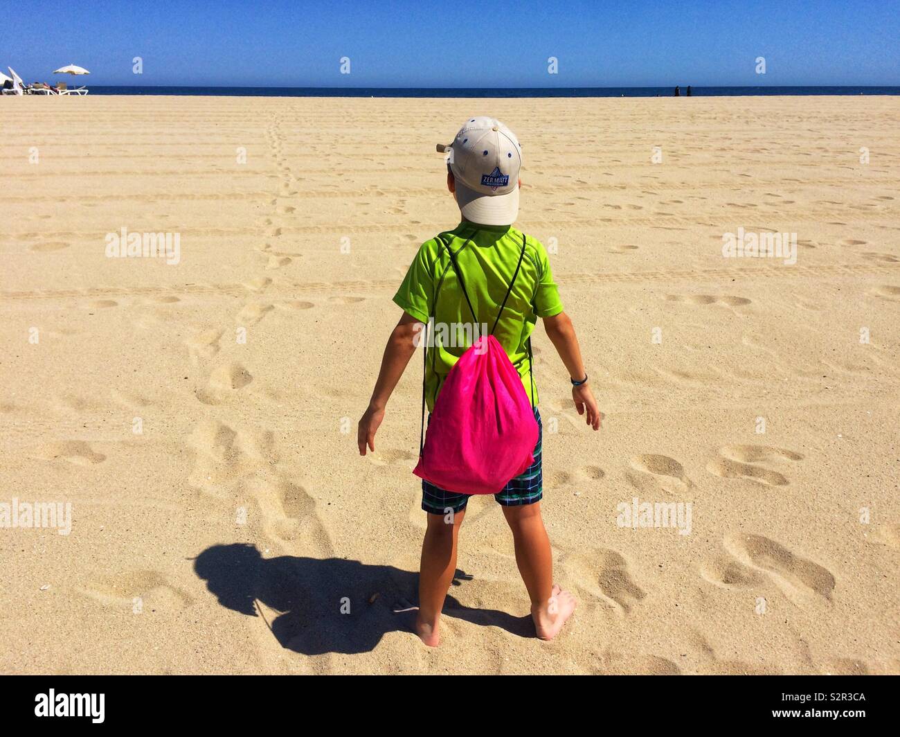 Rear view of a boy standing on beach Stock Photo - Alamy