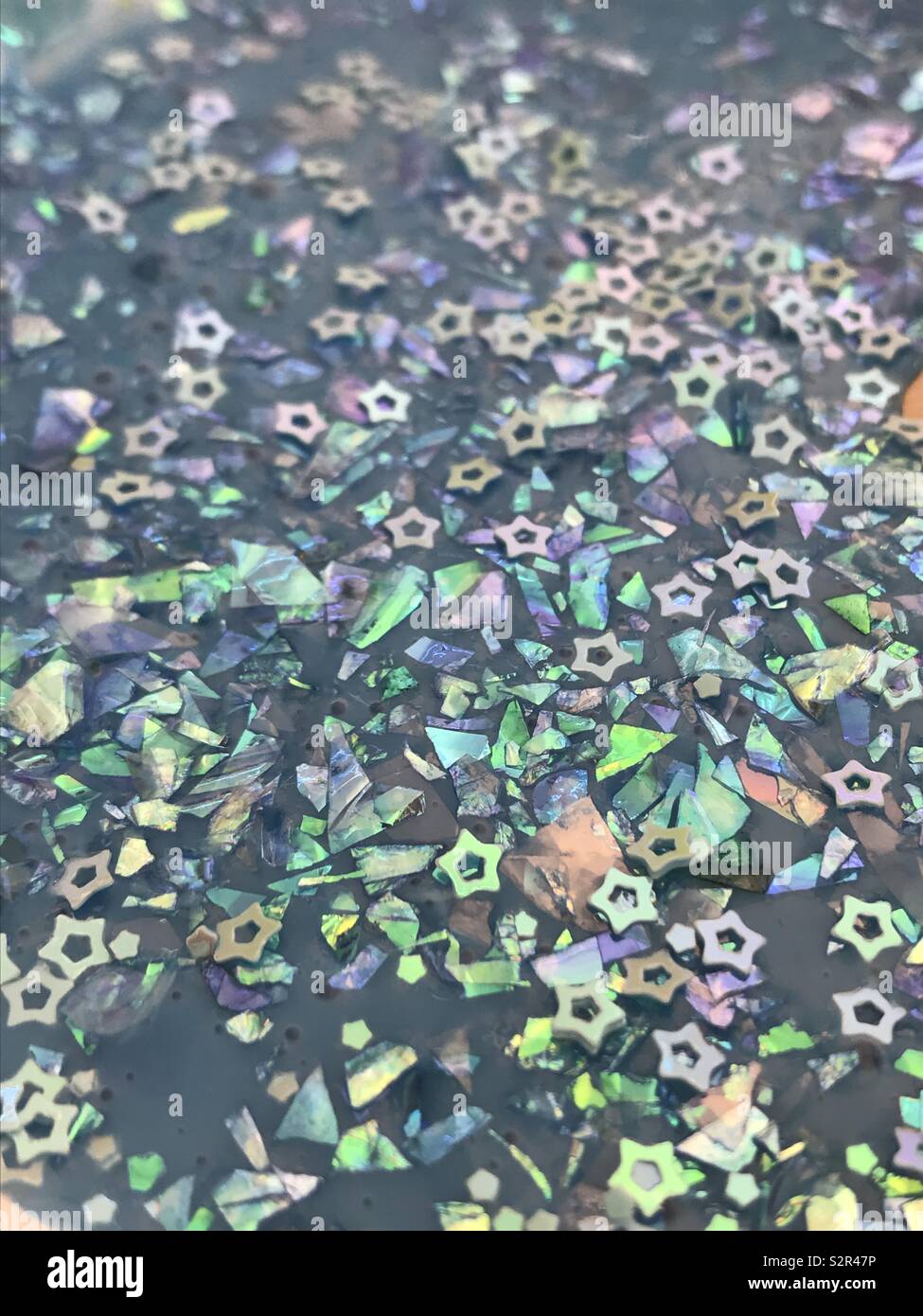 Sequins in slime Stock Photo - Alamy