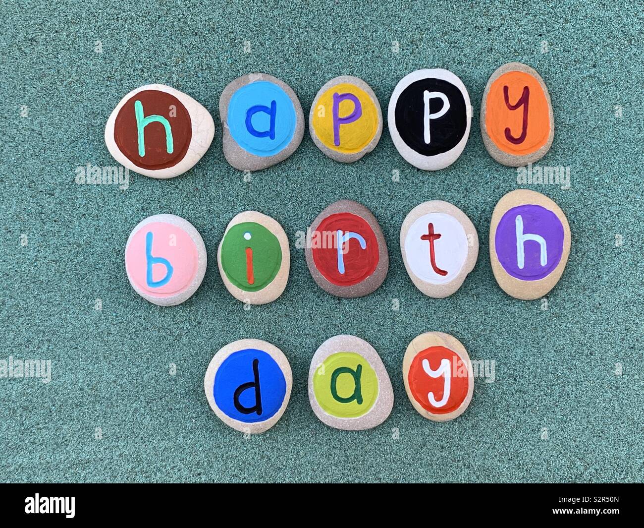Happy Birthday text composed with creative colored stone letters over ...