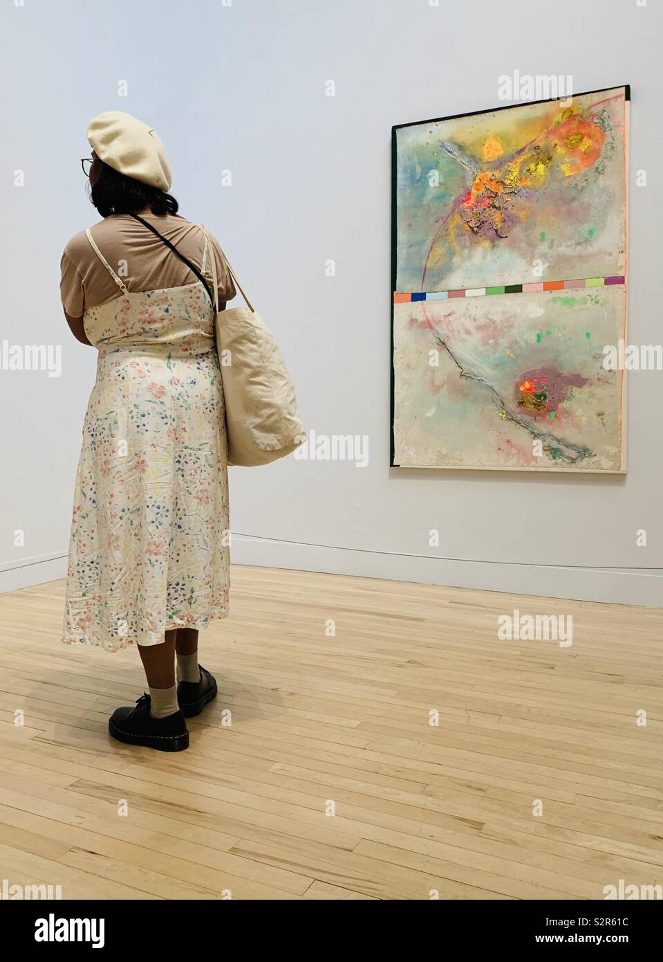 Woman in art gallery matching artwork Stock Photo - Alamy
