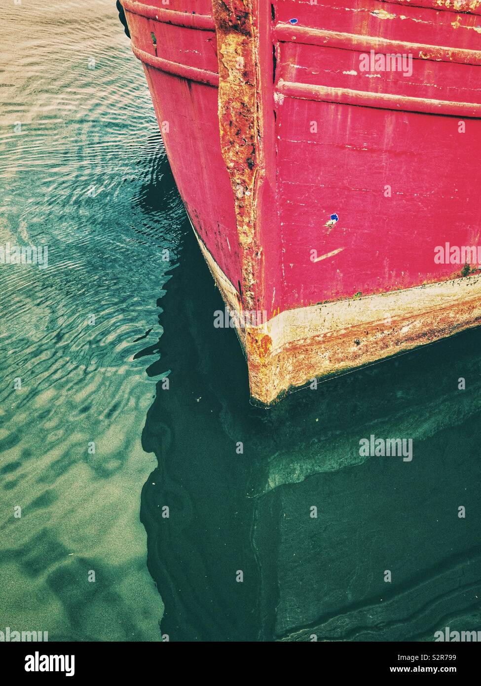 Now of old red boat with reflection in the water Stock Photo - Alamy