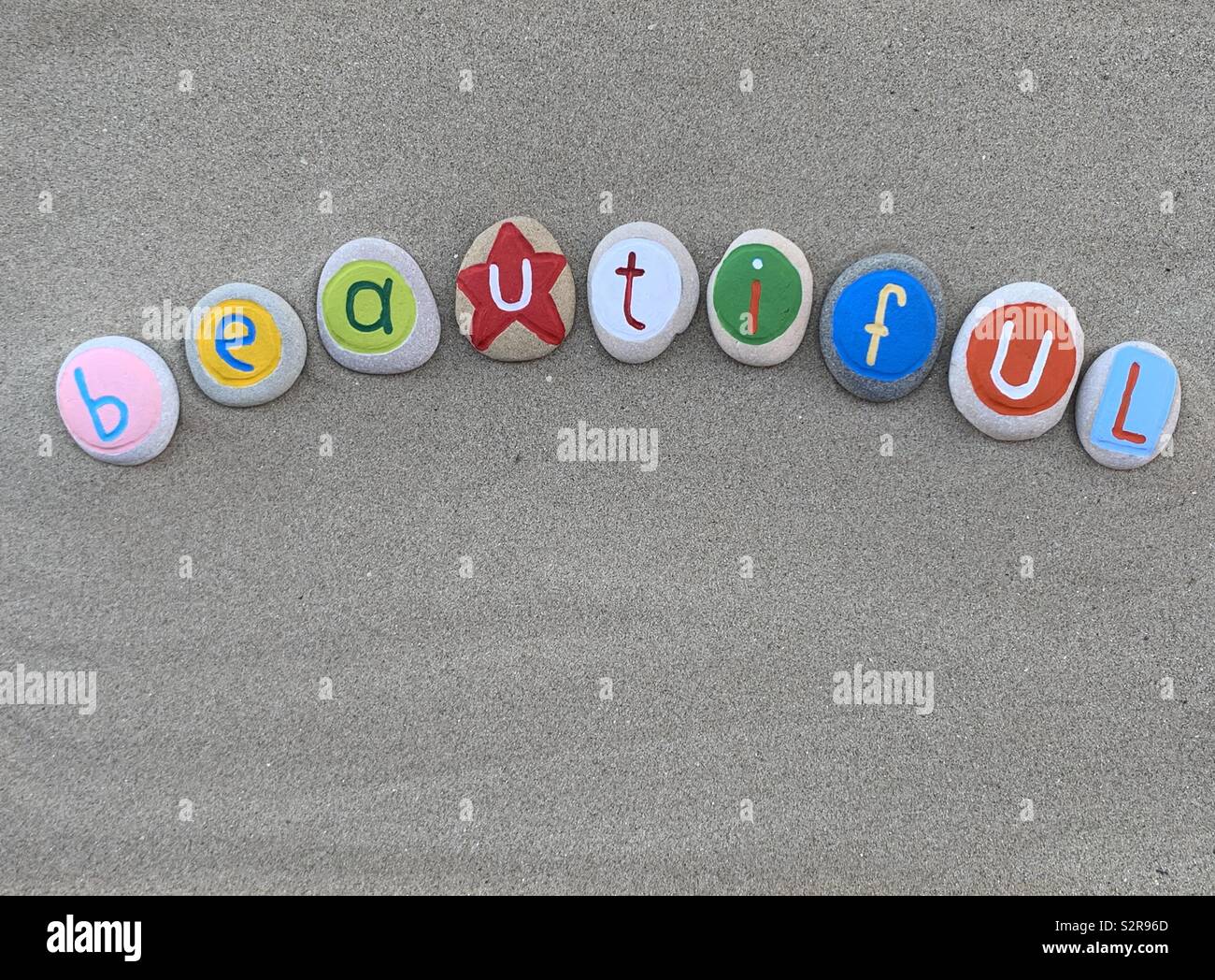 Beautiful word composed with multi colored sea pebble letters over ...