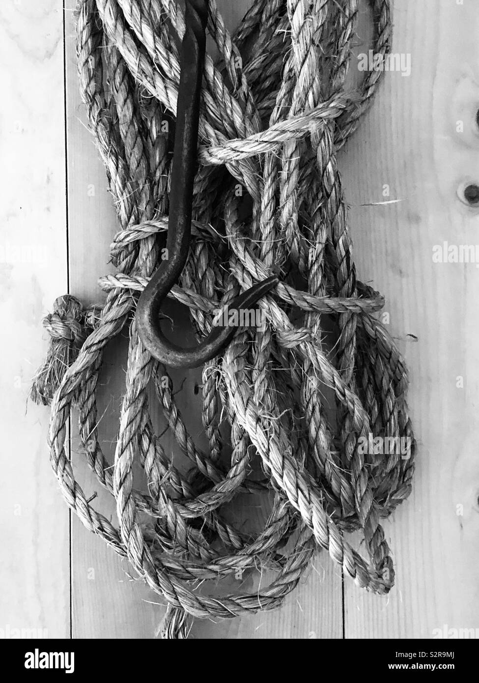 Rope and forged iron hook in the barn on a homestead Stock Photo - Alamy