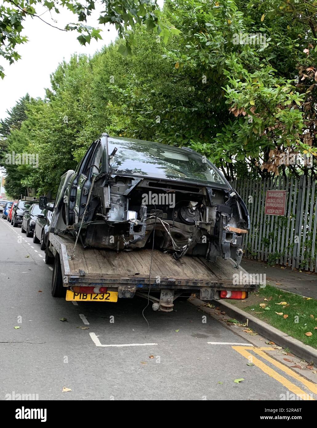 Scrap car on the back of a transporter Stock Photo - Alamy