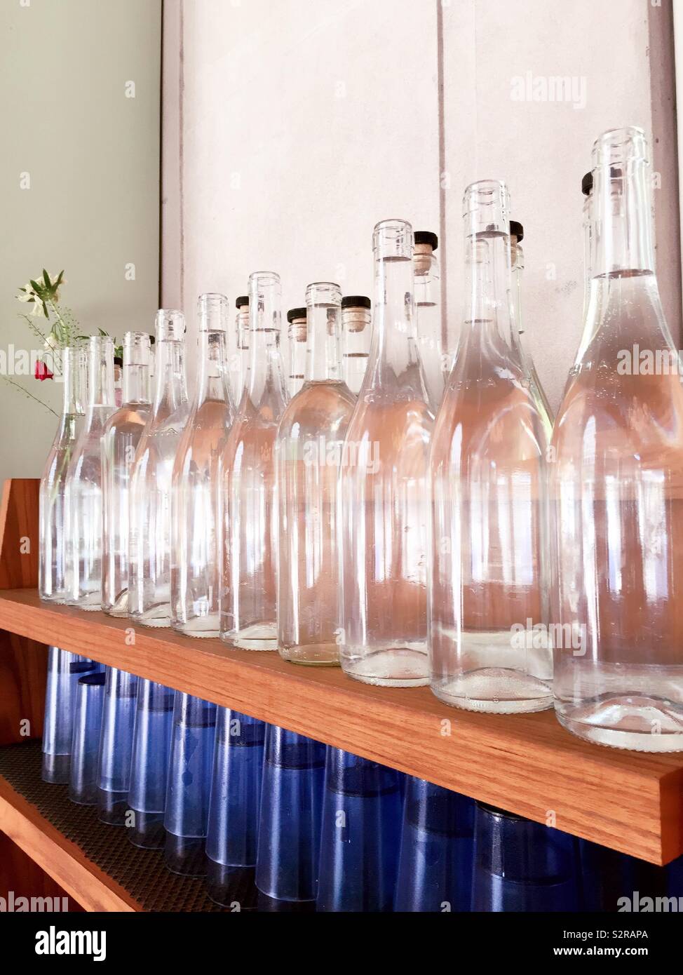 A backlit row of glass water bottles in a restaurant, USA Stock Photo ...