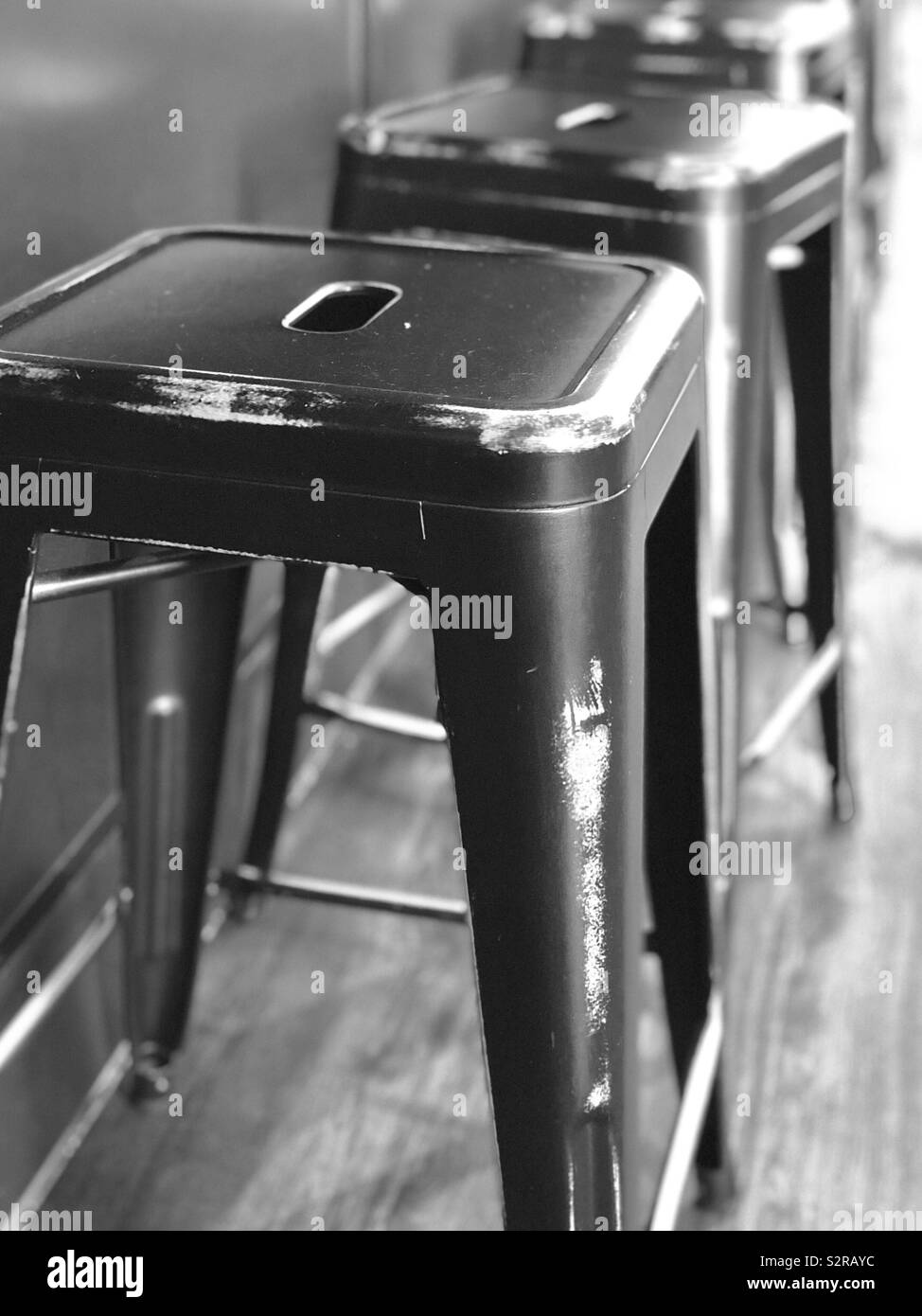 Backless design metallic bar stools. Black color Stock Photo - Alamy