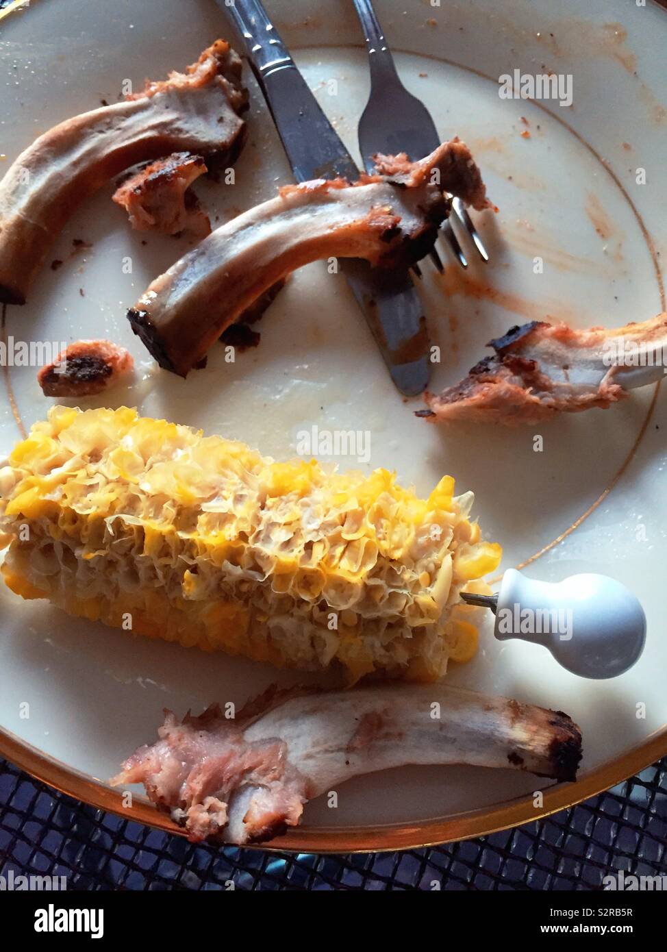 Completely eaten finished meal of baby back ribs and corn on the cob ...