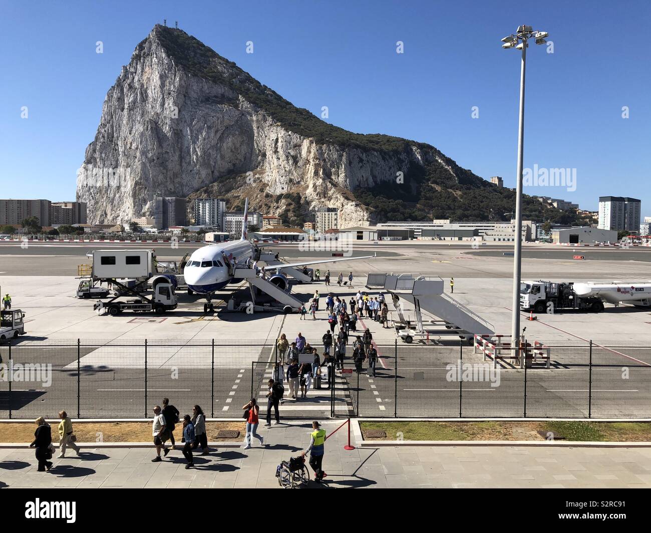 Passengers getting off a BA flight that has just arrived in Gibraltar ...