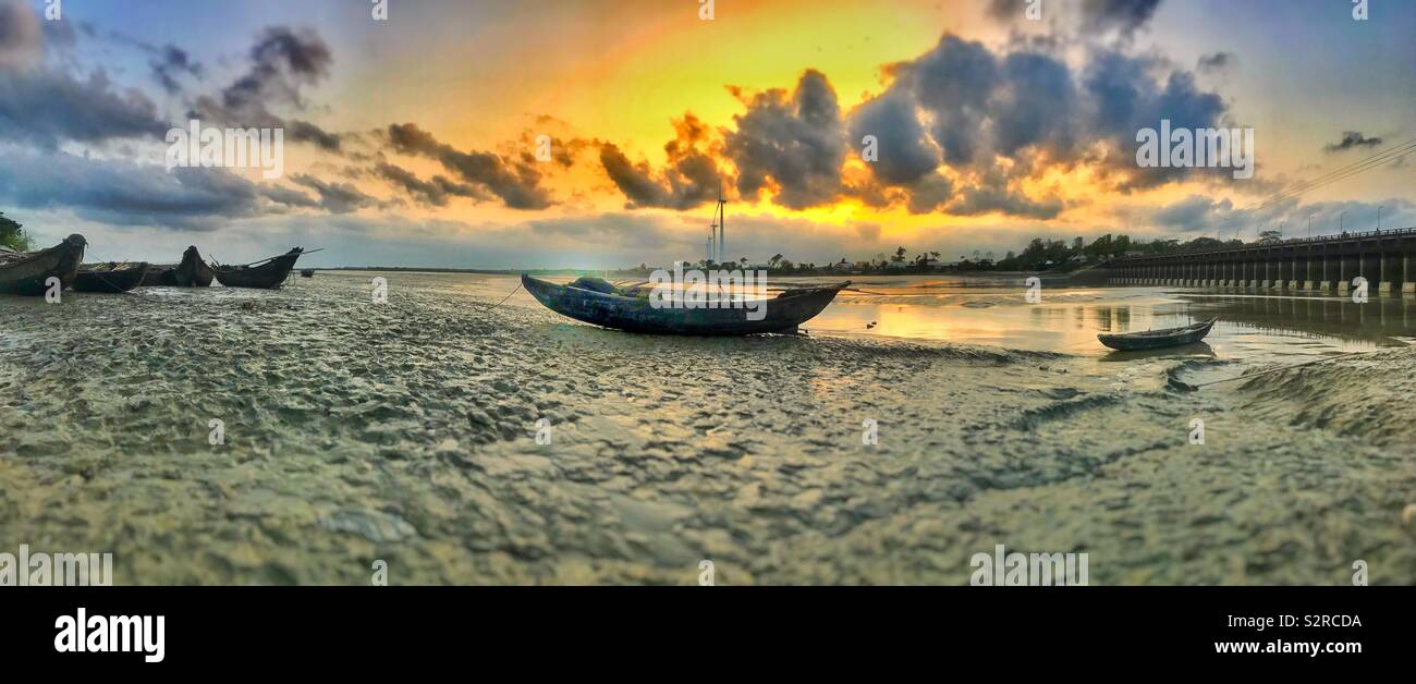 The dull boat sunset in the dry lake Stock Photo - Alamy