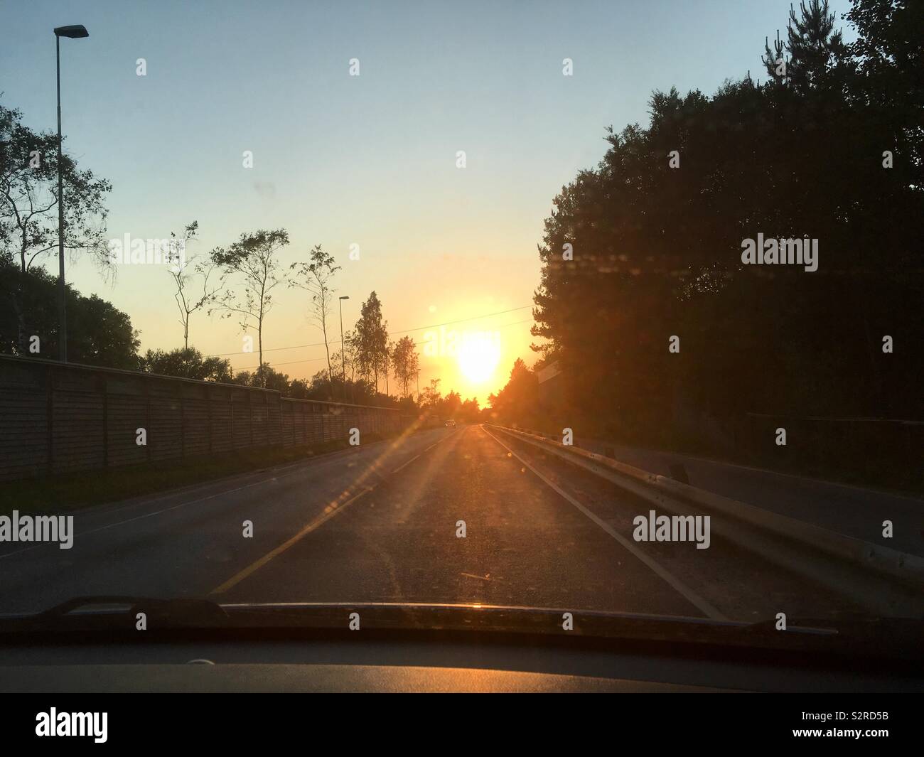 Driving towards the sunset Stock Photo - Alamy