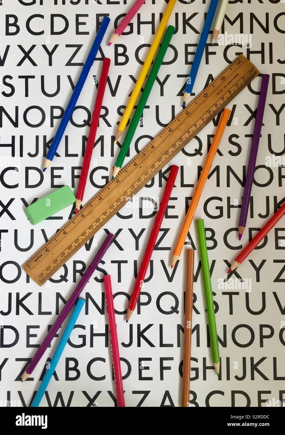 An assortment of multi coloured pencils and writing materials, a ...