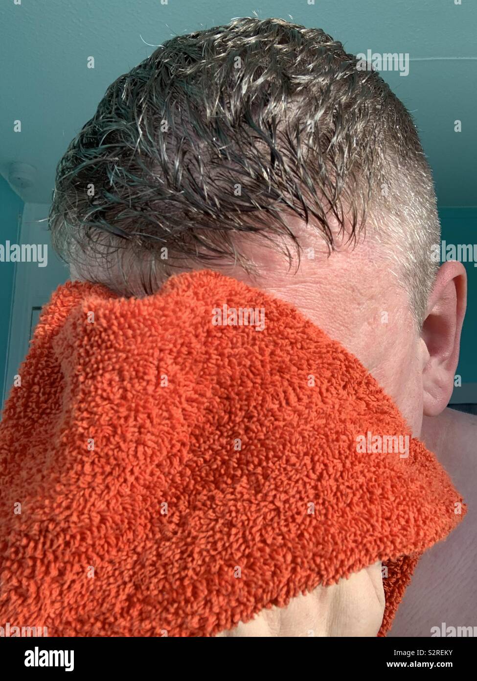 Man drying his face with a towel Stock Photo - Alamy