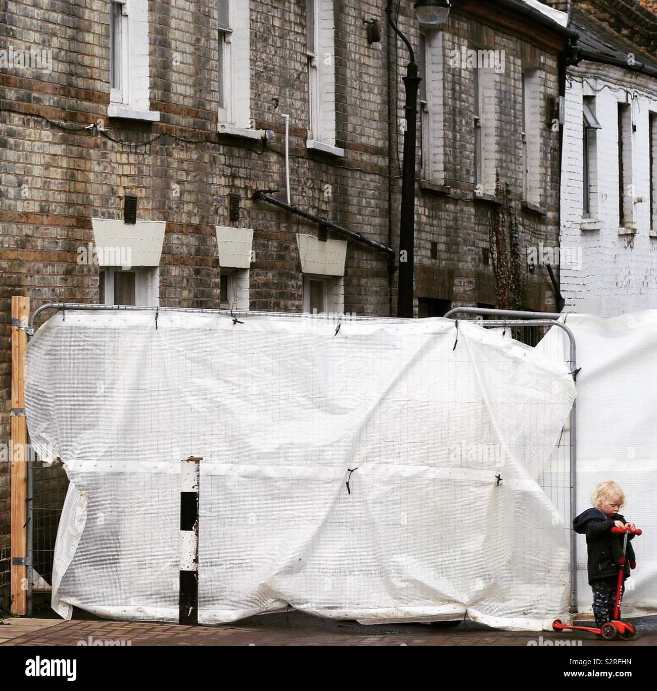 Small boy next to building works Stock Photo - Alamy