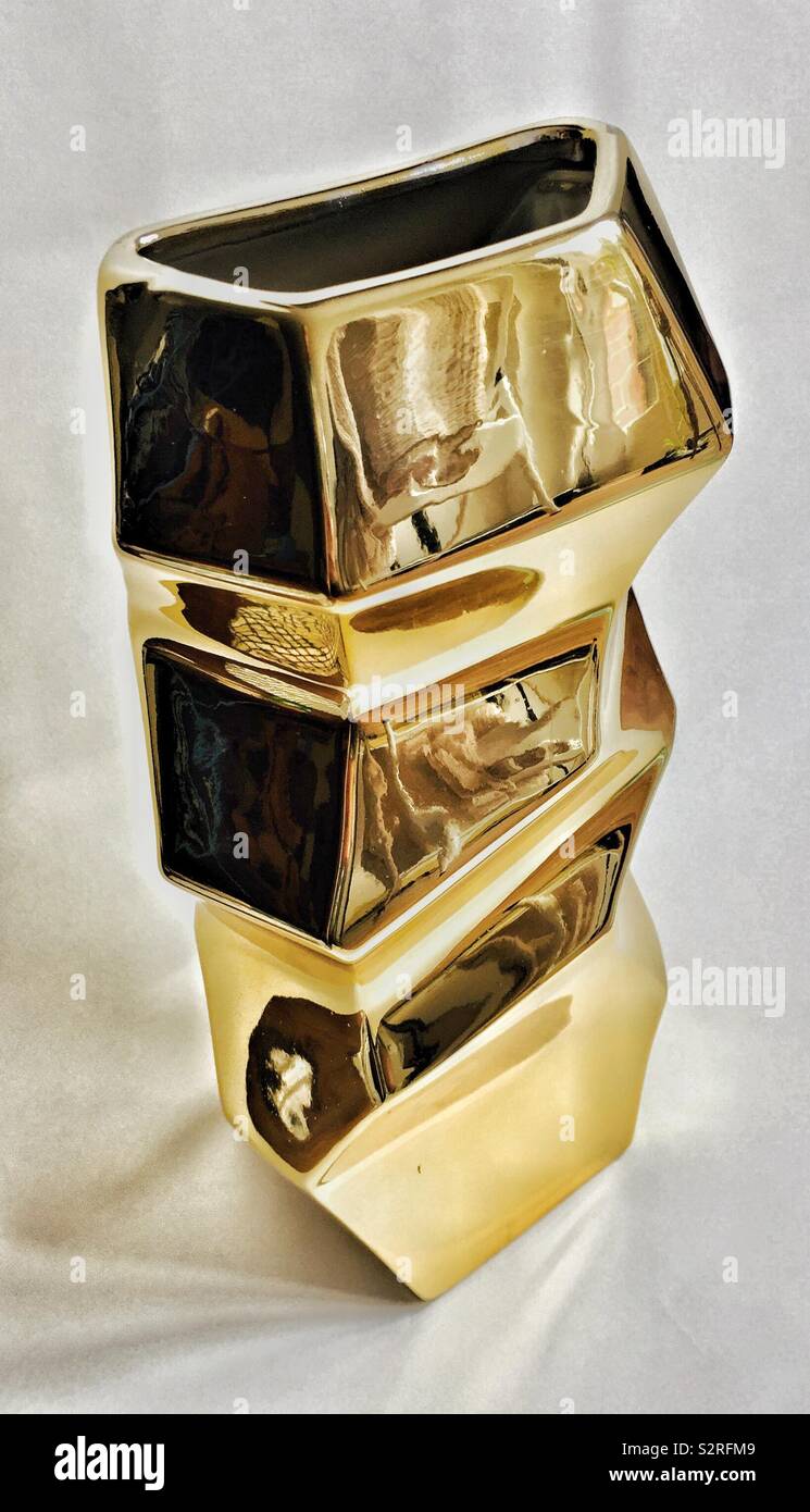 Gold vase of geometric cubist brick design Stock Photo - Alamy