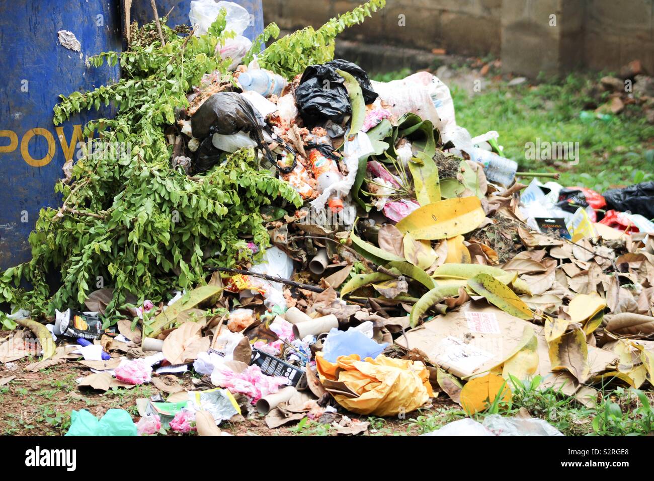 A collection of trash near to a plastic bin Stock Photo - Alamy