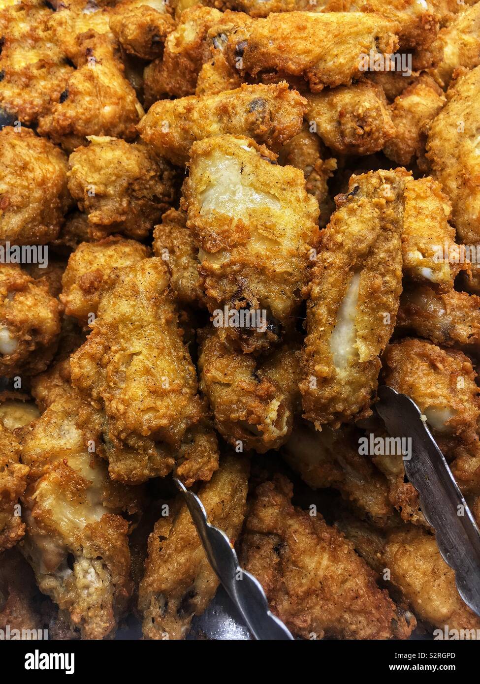 Delicious fresh baked honey chicken served buffet style Stock Photo - Alamy