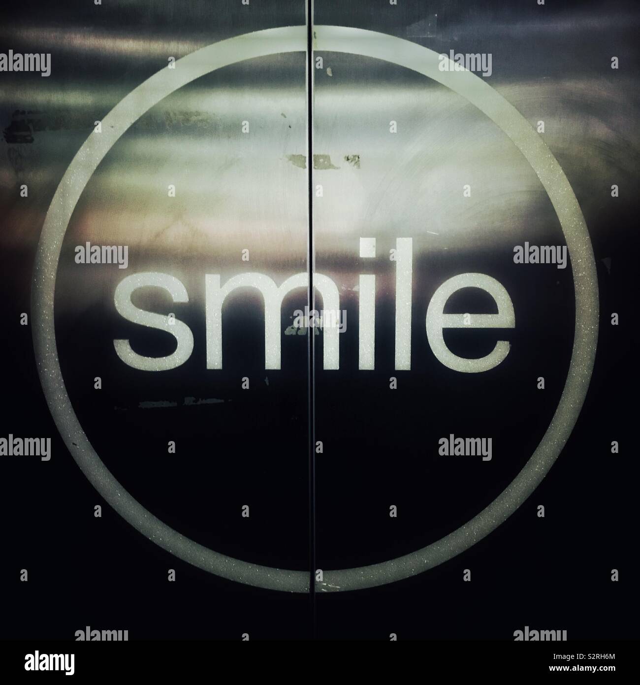 Smile message while waiting for lift door to open Stock Photo - Alamy