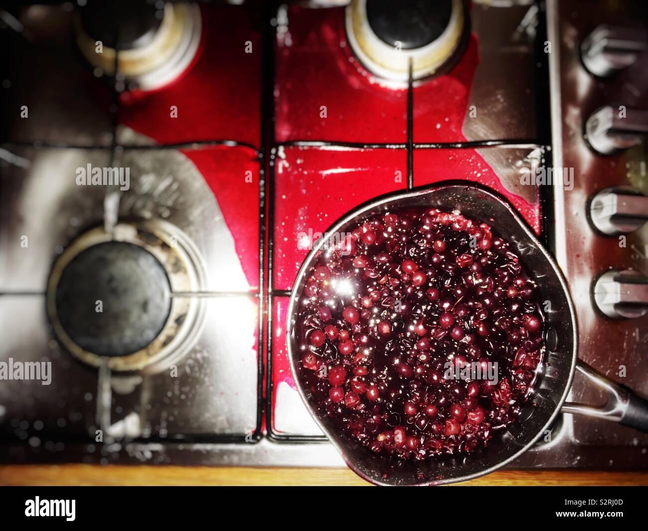 Boiled over red currents Stock Photo - Alamy