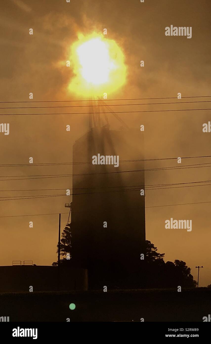 NASA test stand shrouded in fog with distorted sun overhead Stock Photo ...