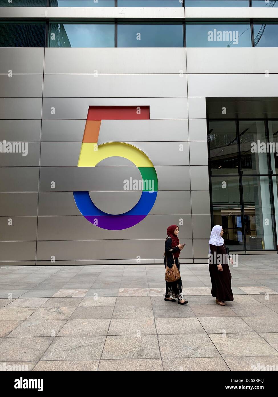 London, UK - 6 July 2019: Two women walk by 5 Broadgate Circle, City of London, EC2M. Rainbow 5 ...