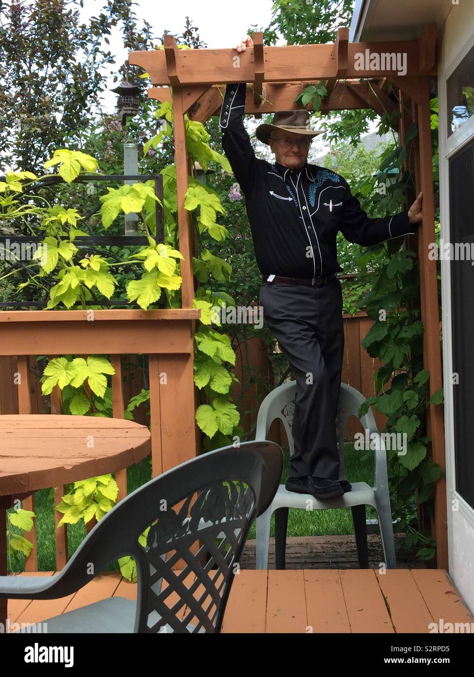 Man standing on a chair Stock Photo - Alamy
