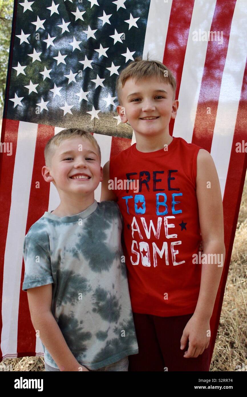 Two Brothers standing in front of the American flag in celebration of ...