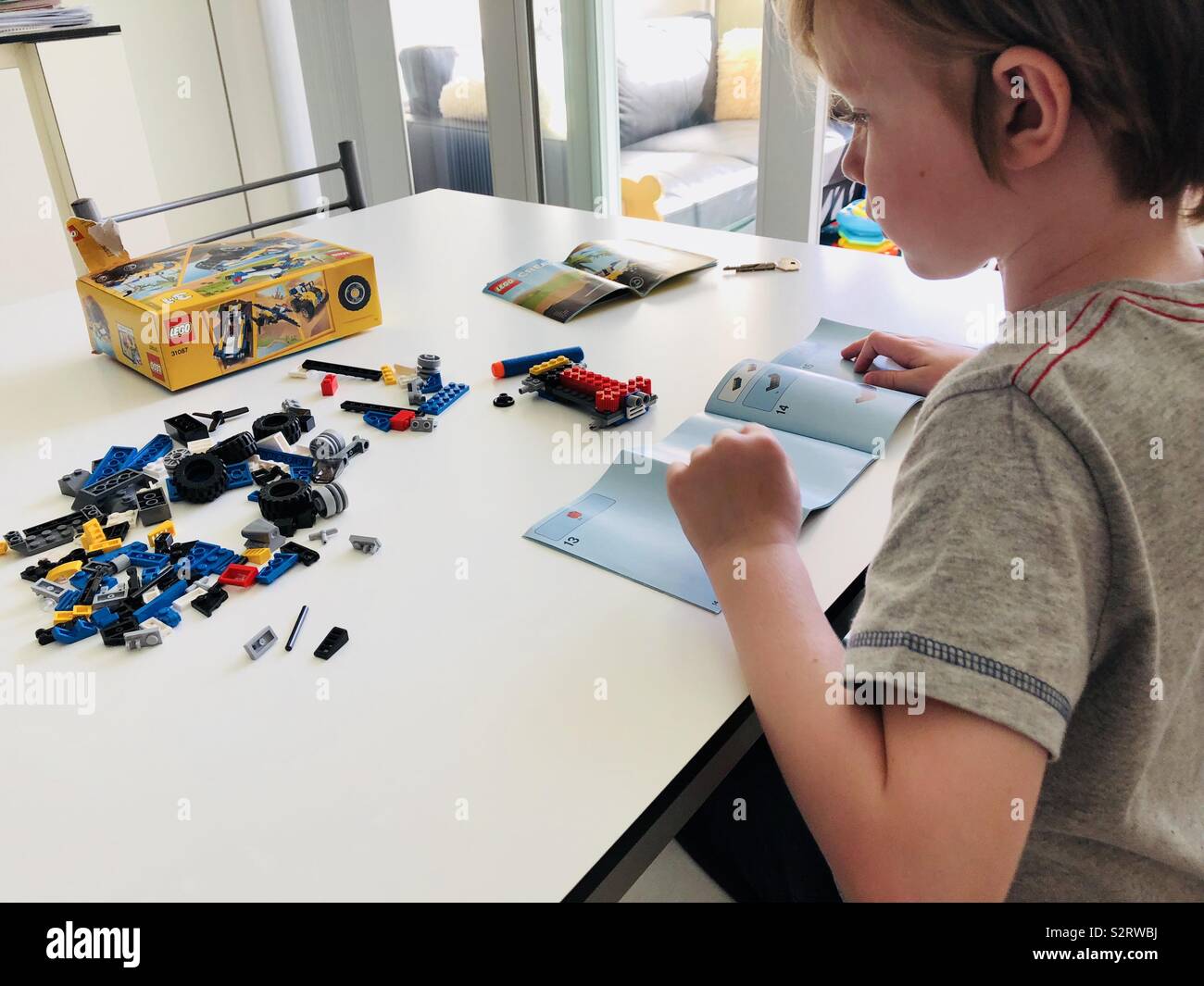 Little boy playing with LEGO Stock Photo - Alamy