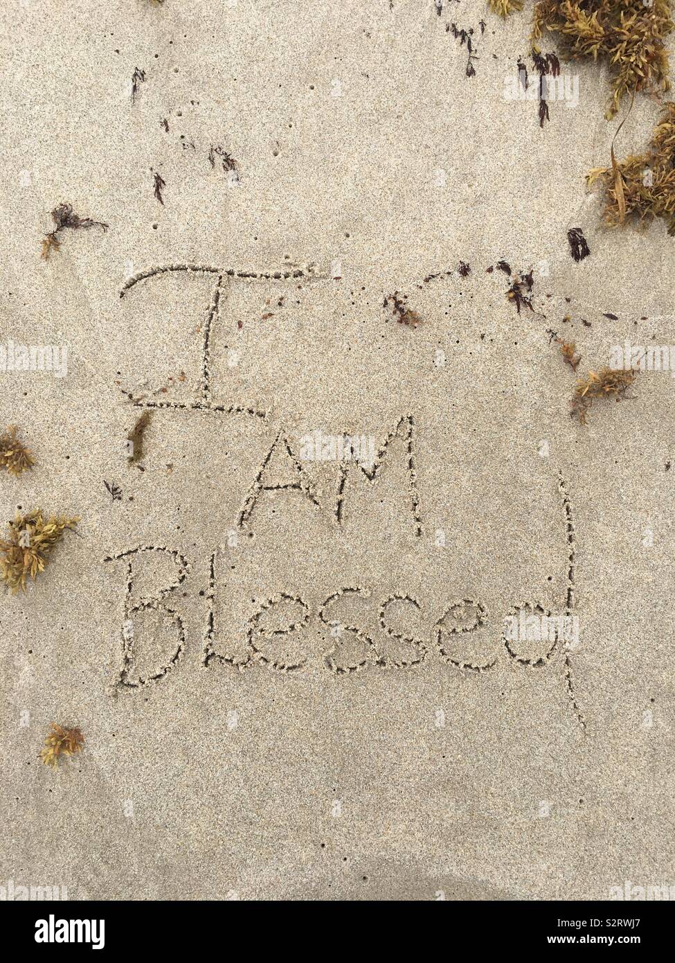 Blessed message in the sand Stock Photo - Alamy