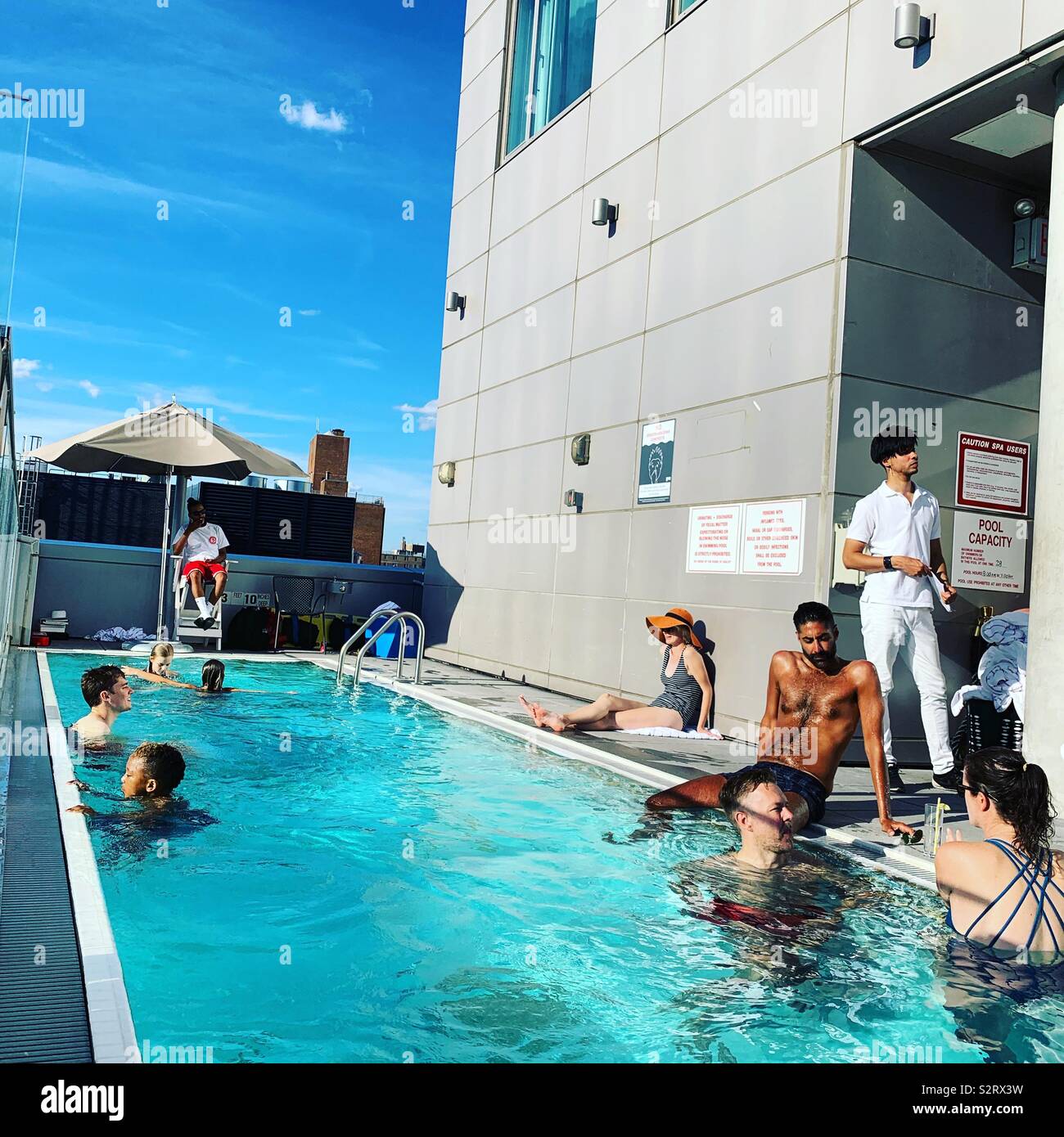 Guests enjoy the pool at the Hotel Indigo Lower East Side, New York ...