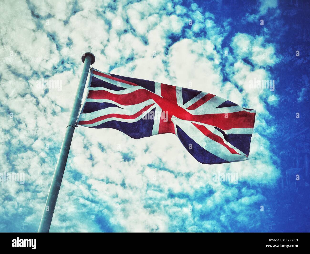 The Union Jack flag flies in the summer sunshine. The flag of The ...