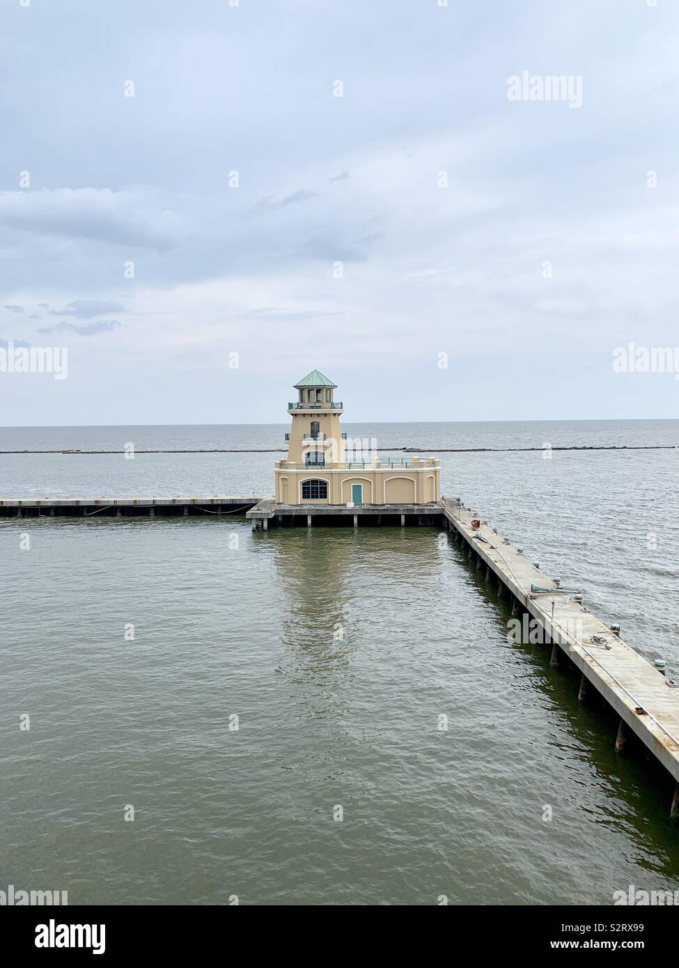 Beautiful lighthouse sitting on ocean water Stock Photo - Alamy