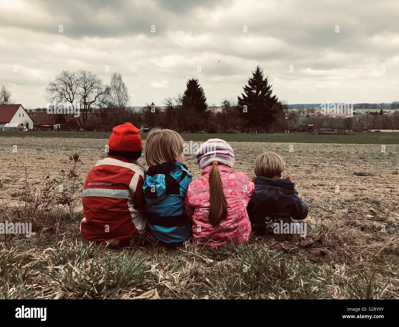 Children sitting in the countryside Stock Photo - Alamy
