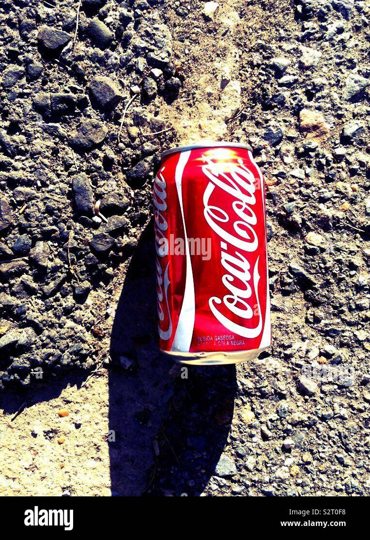 Coca-Cola can tossed in the street Stock Photo - Alamy