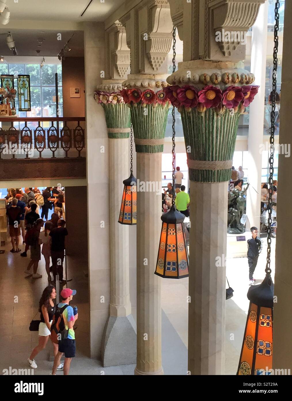 Vibrant and colorful Tiffany lamps hang in the American wing off of ...