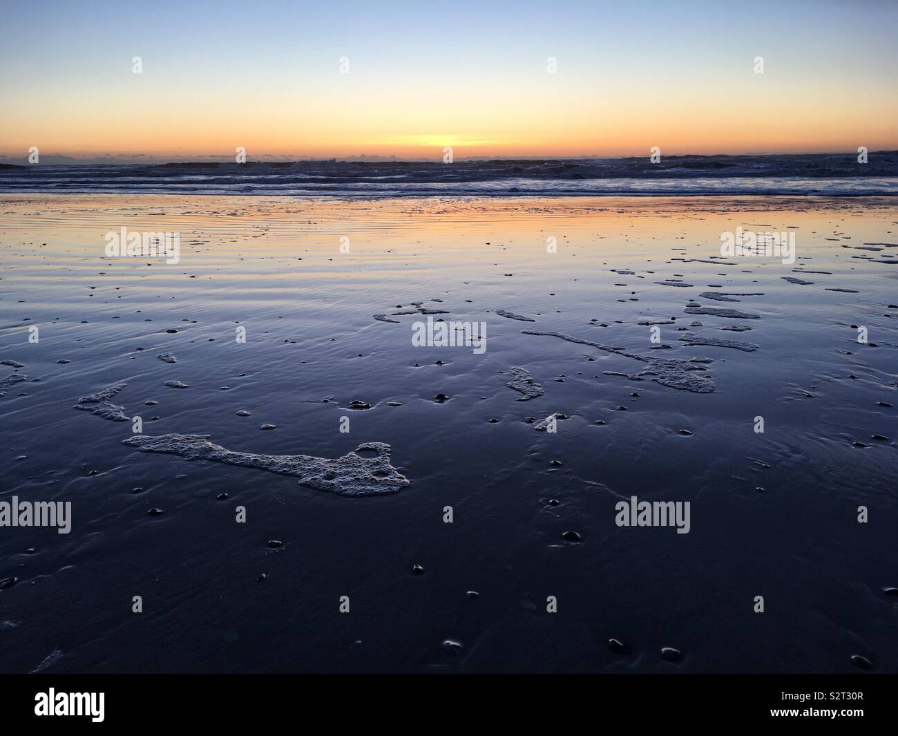 Sunset on the beach Stock Photo - Alamy