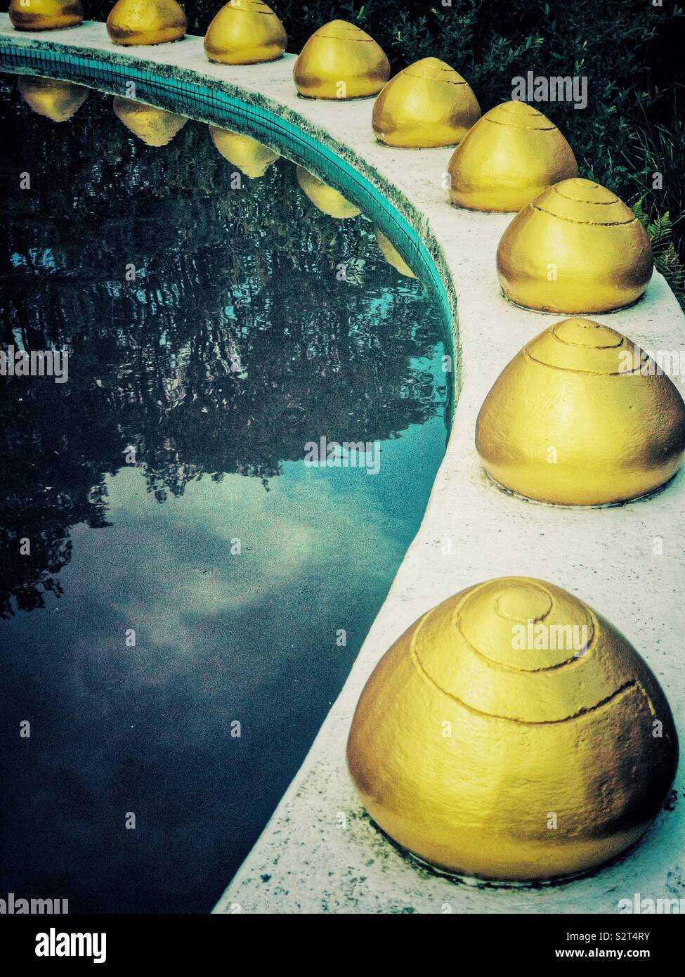 Exterior edge of a Buddhist water feature Stock Photo - Alamy