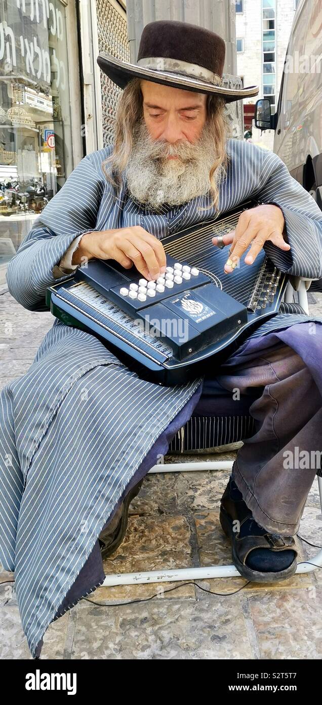 A Jewish Hasidic man playing music in the streets of Jerusalem Stock ...