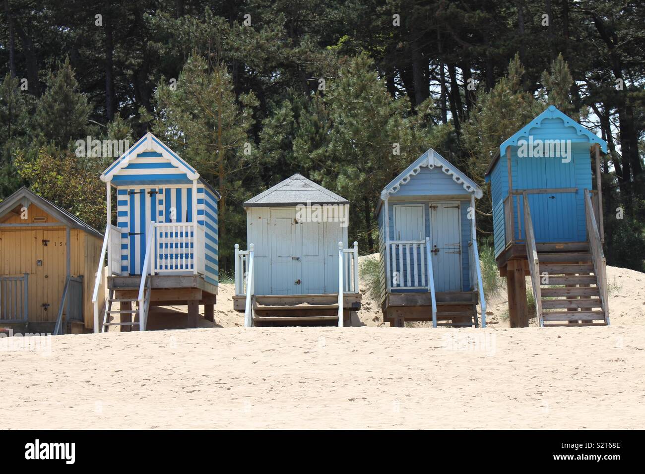 Blue striped beach huts on Norfolk beach Stock Photo - Alamy