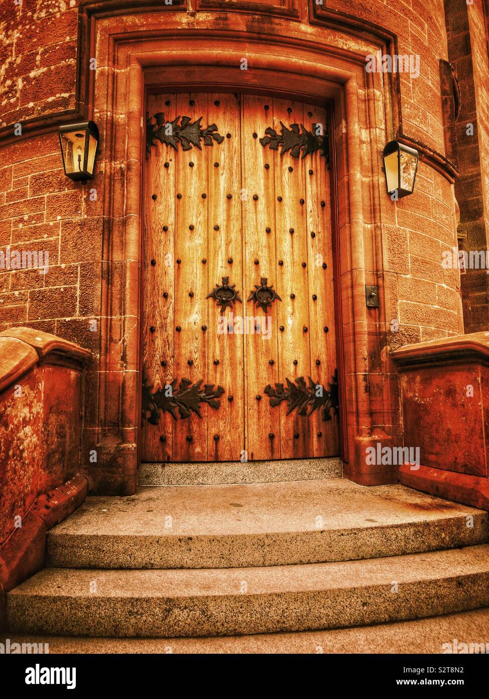 Steps and large wooden door of Scottish baronial style house Stock ...