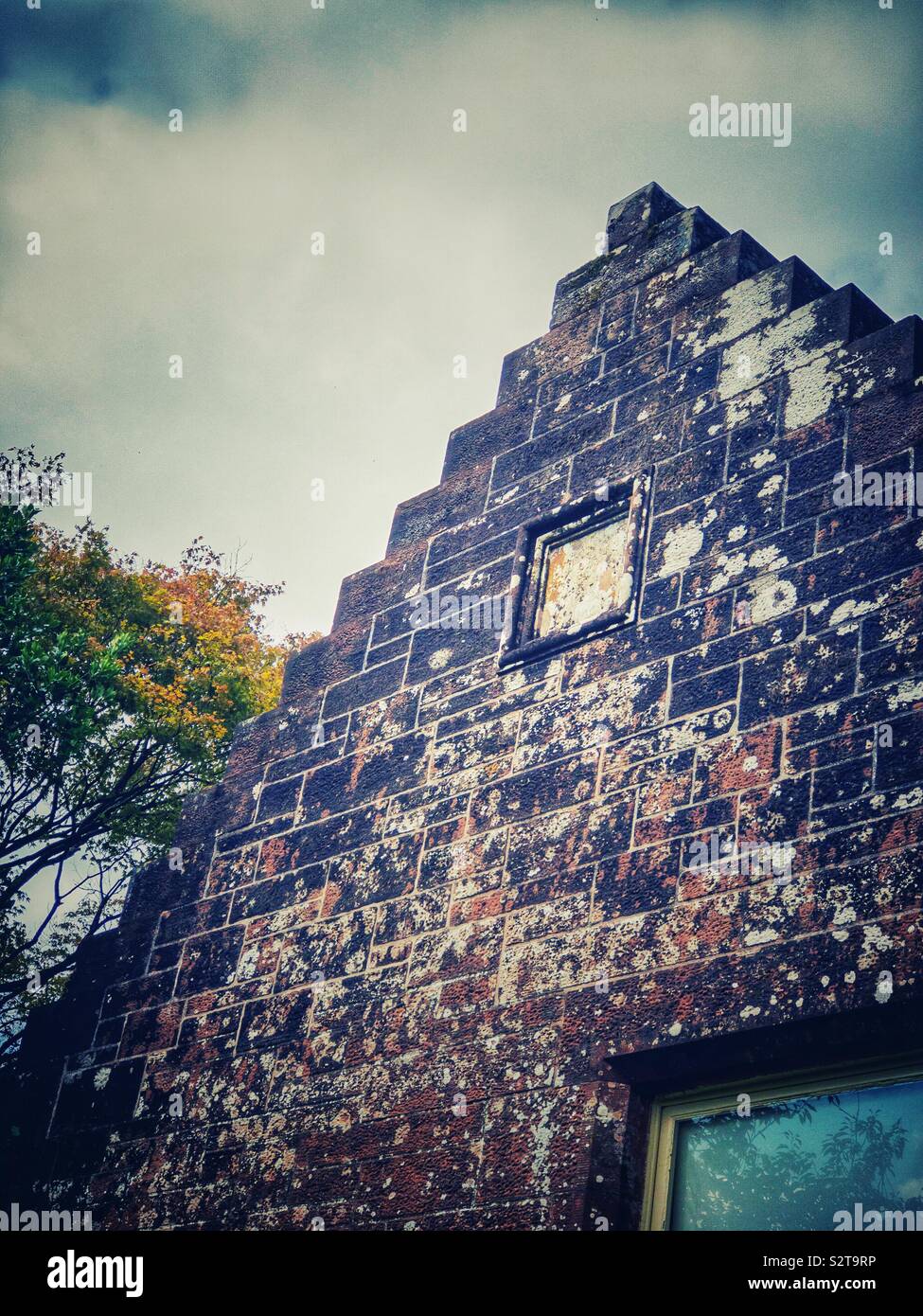Side of castellated style building against sky Stock Photo - Alamy