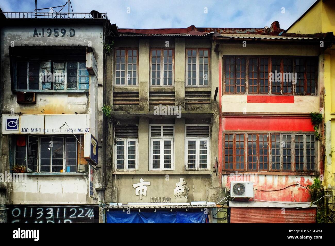 The façades of terraced shophouses in the old Main Bazaar at Kuching ...