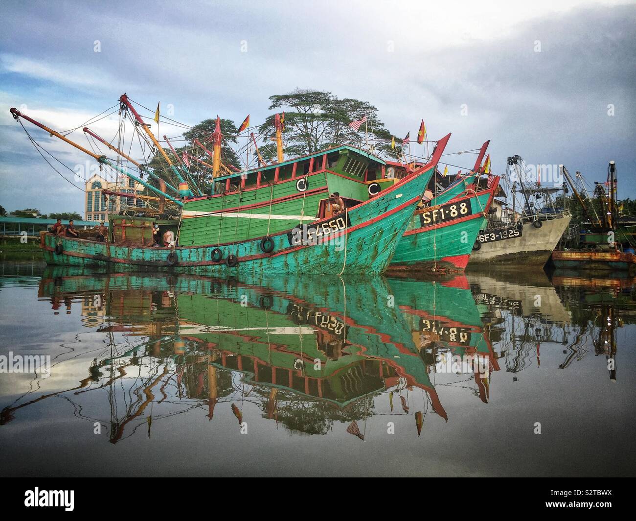 Fishing boats moored on the Sarawak River, Kuching, Sarawak, Malaysia ...