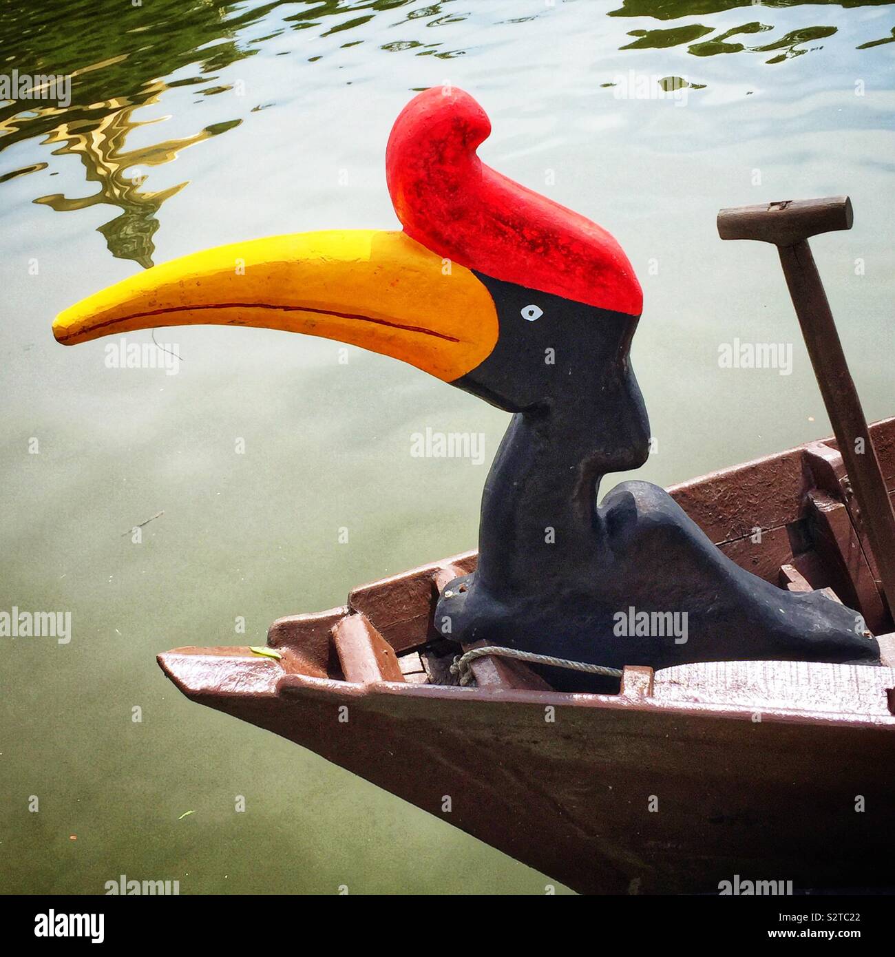 The stylised carved and painted wooden hornbill bird as figurehead on a ...