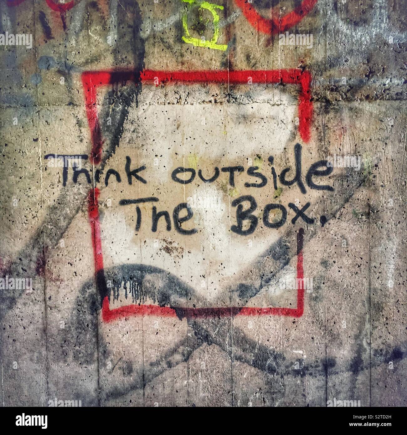 Think outside the box graffiti on outside wall Uk Stock Photo - Alamy