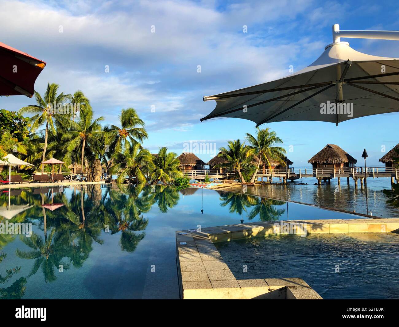Infinity pool, spa, and over water bungalows at a resort on Moorea ...