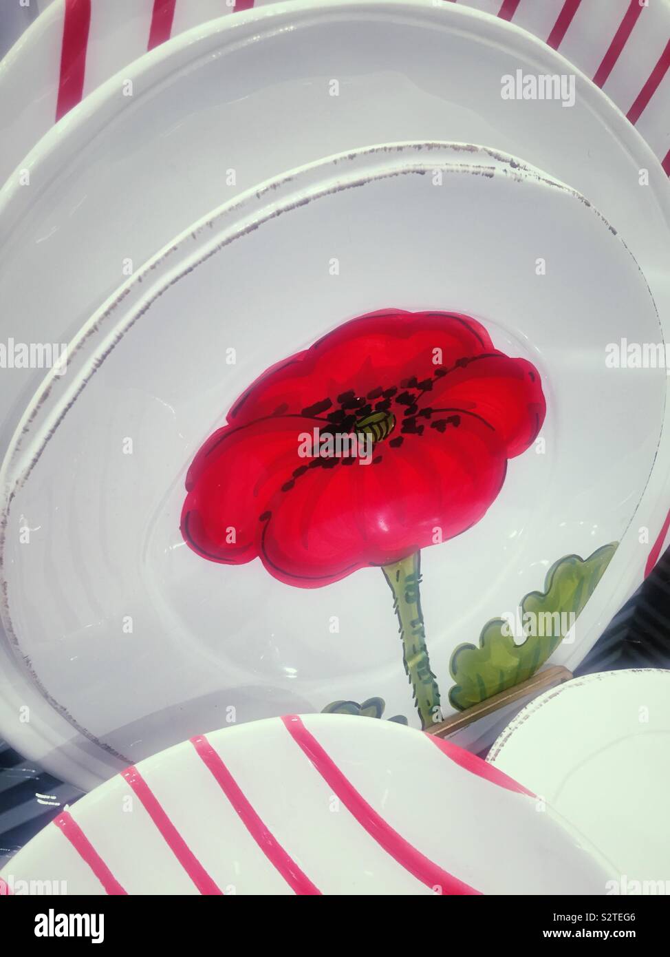 China plate with a single red poppy pattern for sale in an upscale ...